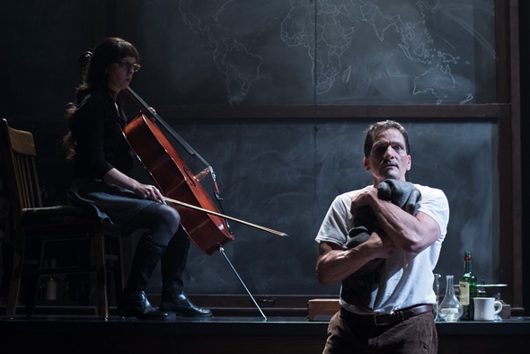 As the Muse (Alicia Storin) looks on, Jim DeVita portrays Andromache ...